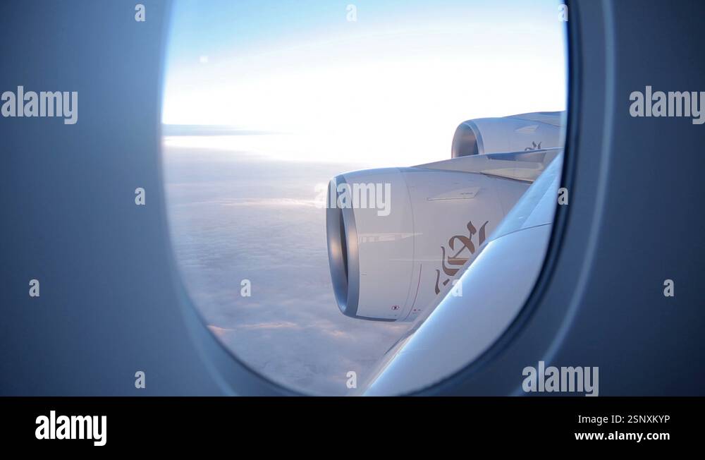 view through window of emirates a380 airplane as it flies through ...