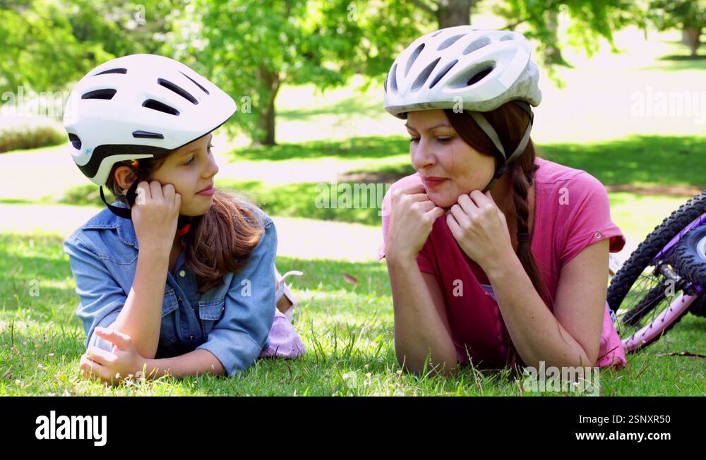 Mother and daughter taking a break on their bike ride in the park Stock ...