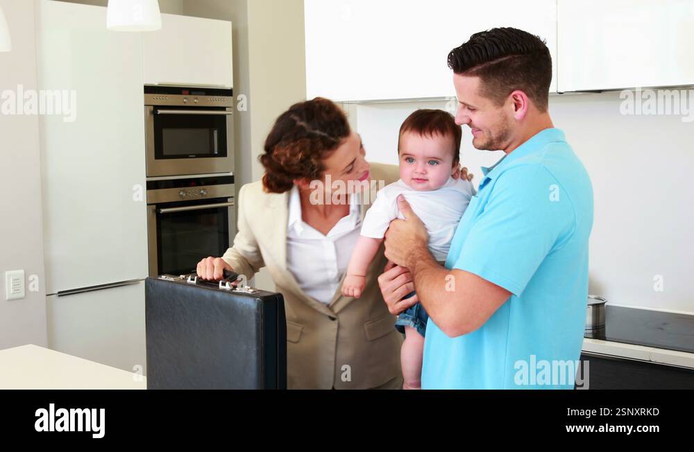 Working mother waving goodbye to house husband and baby Stock Video ...