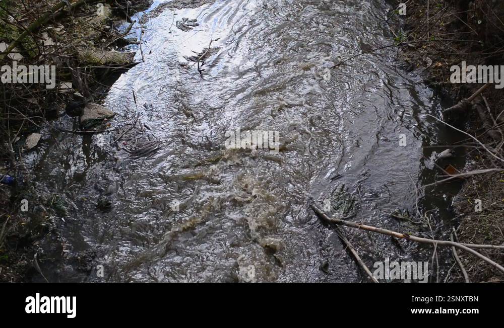 Water pollution. Waste water flowing and polluting environment Stock ...