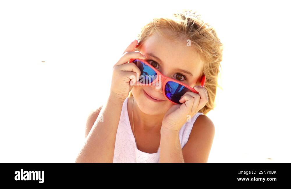 Little beach girl making faces with sunglasses Stock Video Footage - Alamy