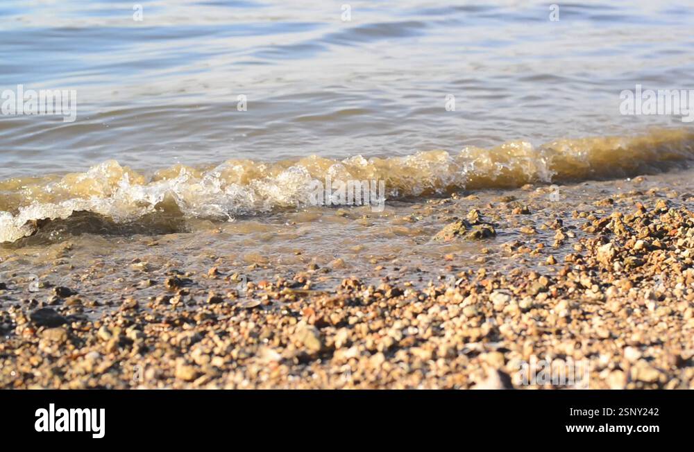 River bank with pebbles and waves of splashing water Stock Video ...