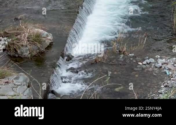 Waterfall on mountain river in town, Italy. River after rain. Nature ...