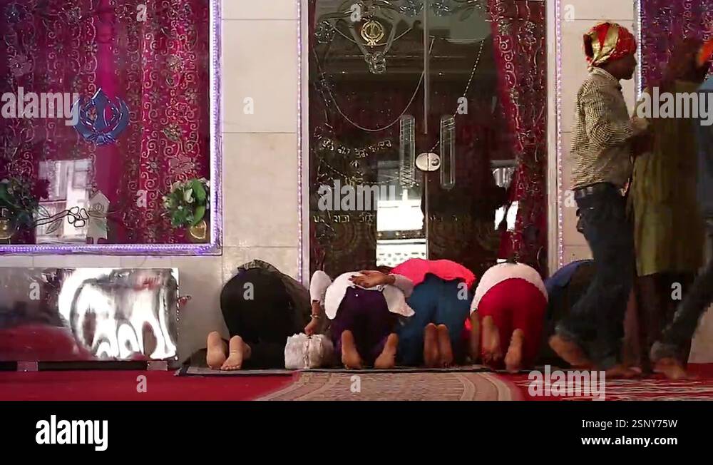 Sikhs worship and pray at a holy site in India Stock Video Footage - Alamy