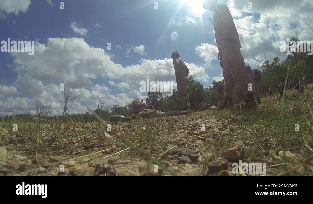 low angle view of army instructors and soldier in firing position on ...