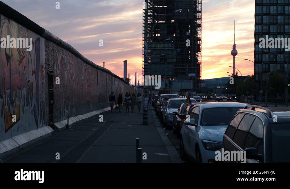 Pedestrians near berlin wall with iconic TV tower in background, Berlin ...