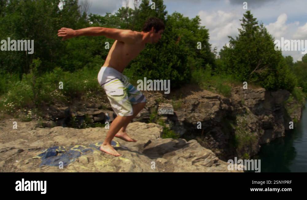 Young People Having Fun in the Summer - Jumping off a Cliff Backflip ...