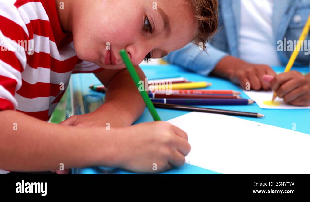 Cute little boys colouring in classroom Stock Video Footage - Alamy