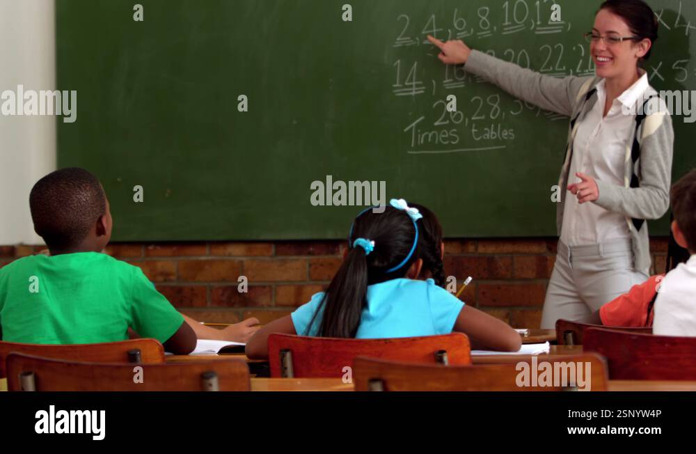 Young teacher teaching math to young class in classroom Stock Video ...