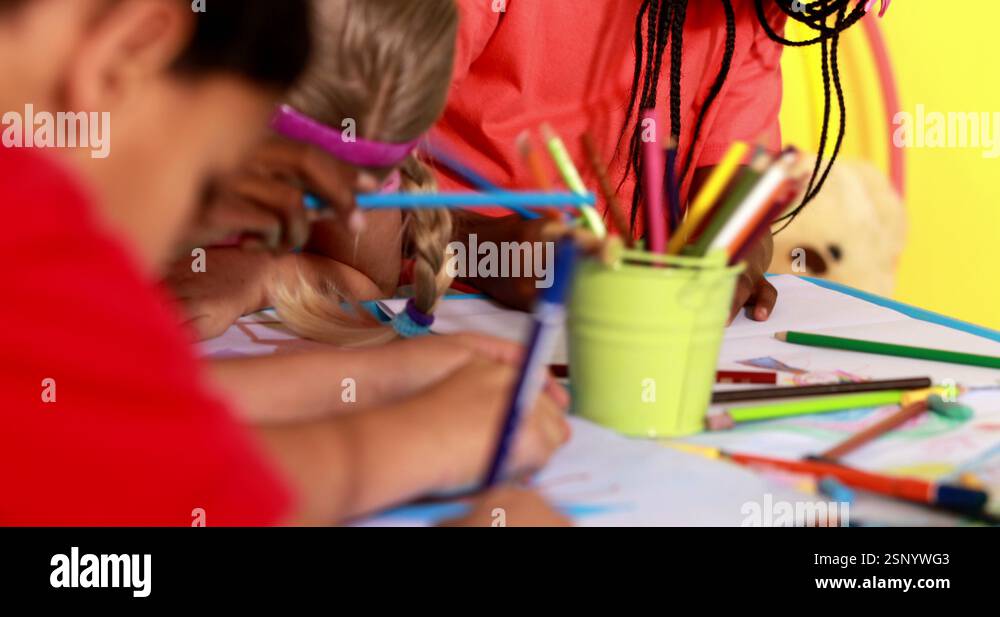 Preschool class drawing at table in classroom Stock Video Footage - Alamy