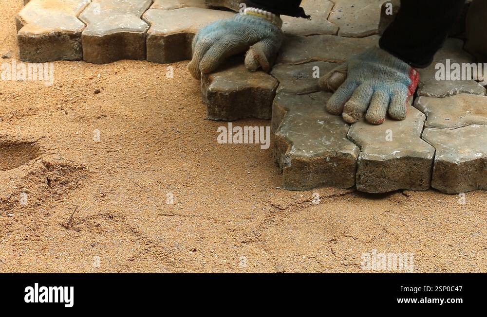 worker installing old cobblestone block for build floor ground Stock ...