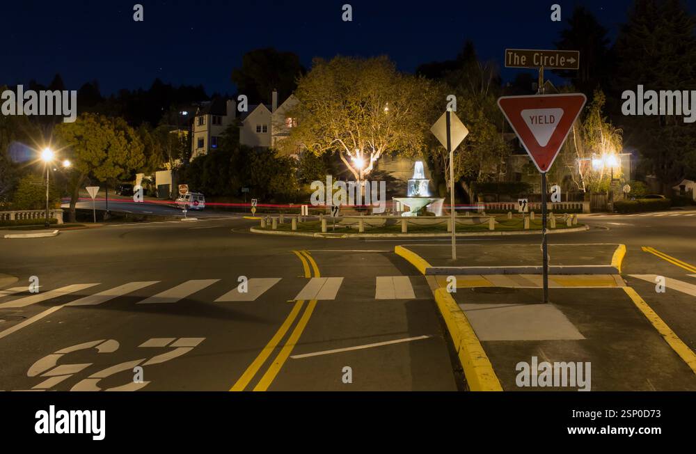 4k time lapse of cars going around a traffic circle and fountain at ...