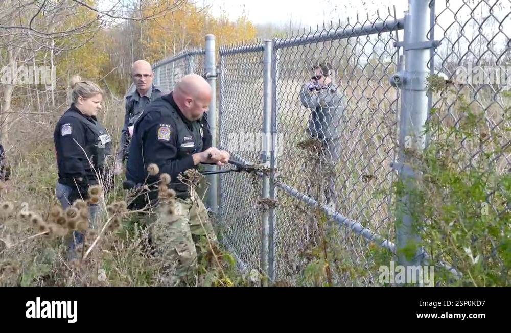 Police officers with tactical army pants cutting open a chain with bolt ...