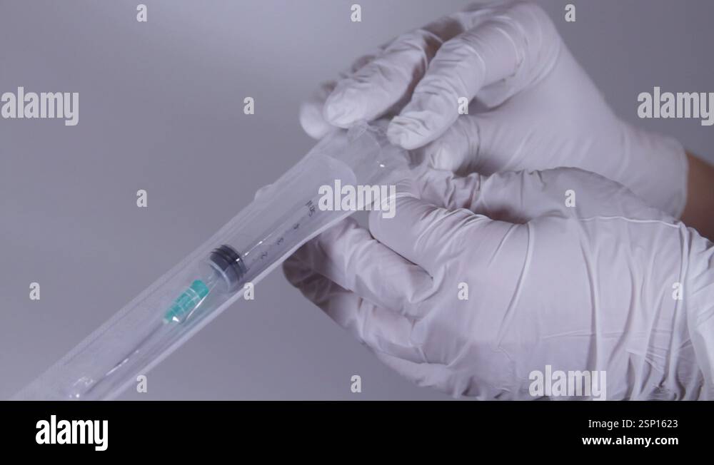 Nurse's Hands Opening Up A Single Use Syringe From It's Package ...