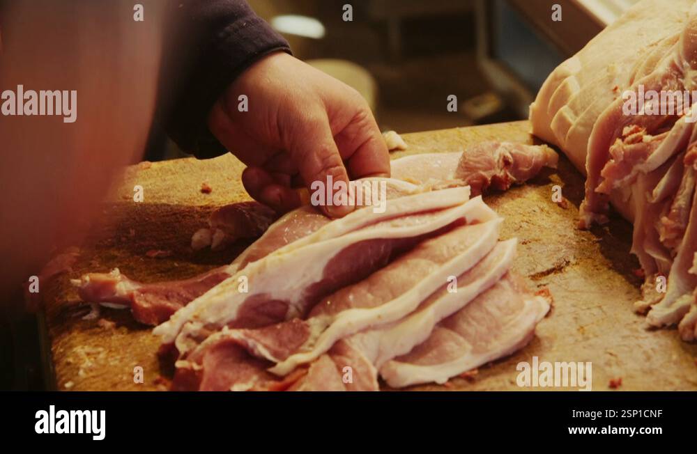 Close up butcher cutting/slicing meat on slab Stock Video Footage - Alamy