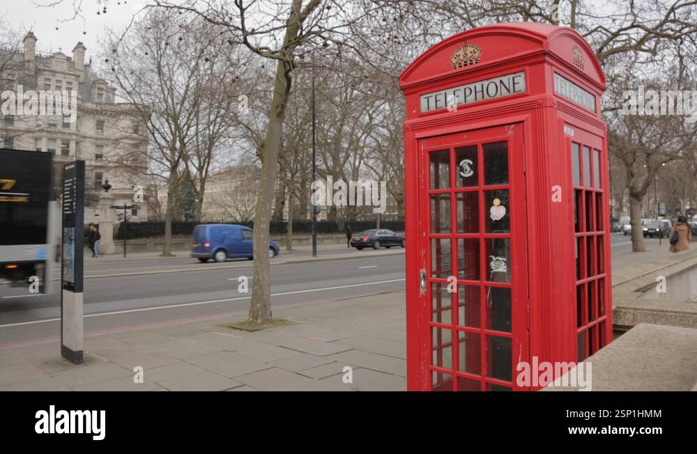 Red Telephone Box with cars driving by Stock Video Footage - Alamy