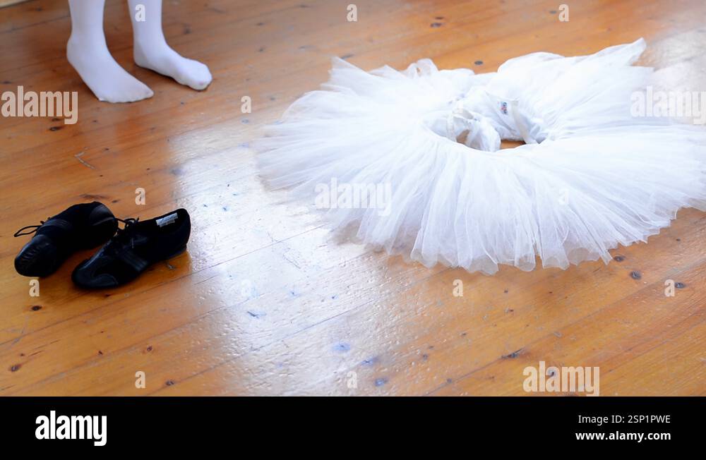 ballet - skirt and shoes on the floor (block parquet) - foots of ...