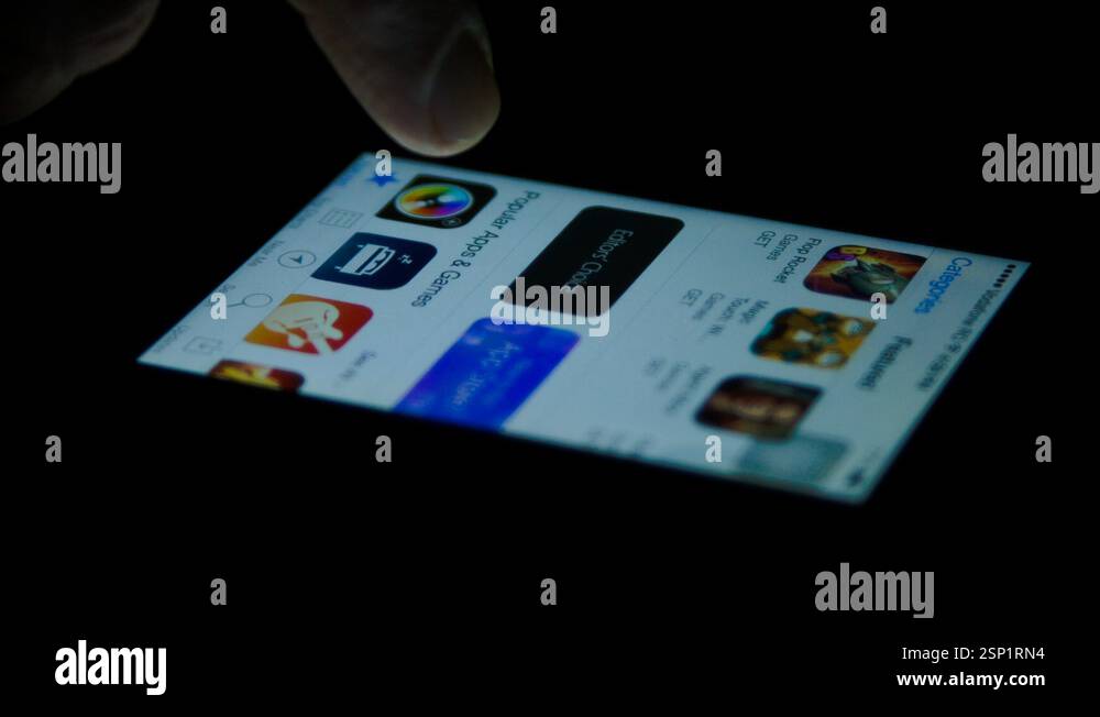 Woman Finger Scrolling Thru Applications On A Smart Phone Late At Night ...