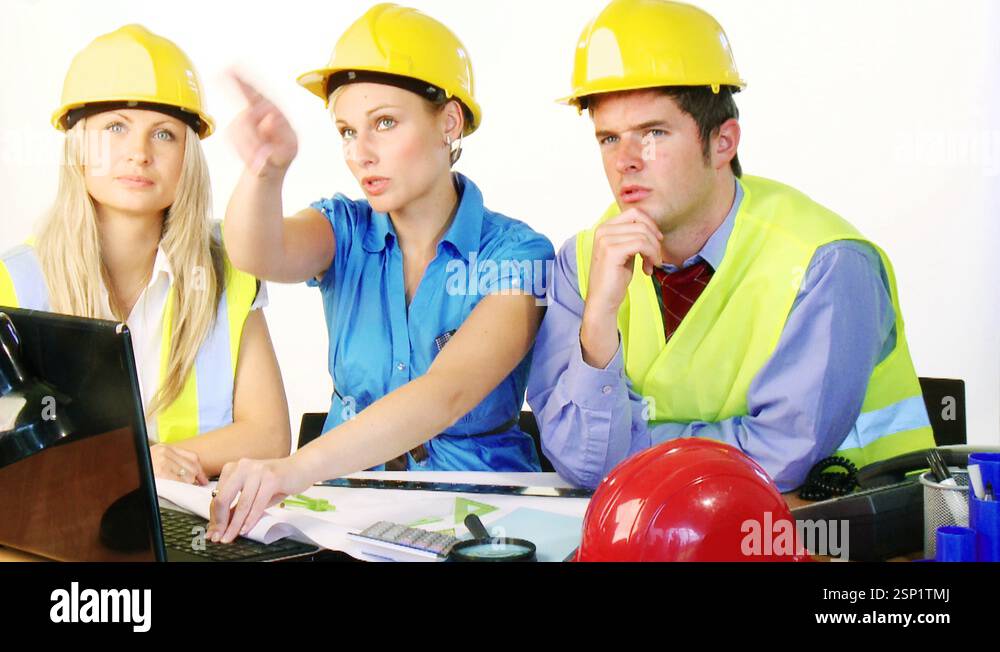 Architects using a laptop and smiling at the camera in office Stock ...