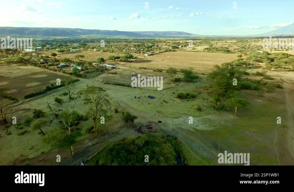 African church in a village with kids at sunset by a well, moving ...