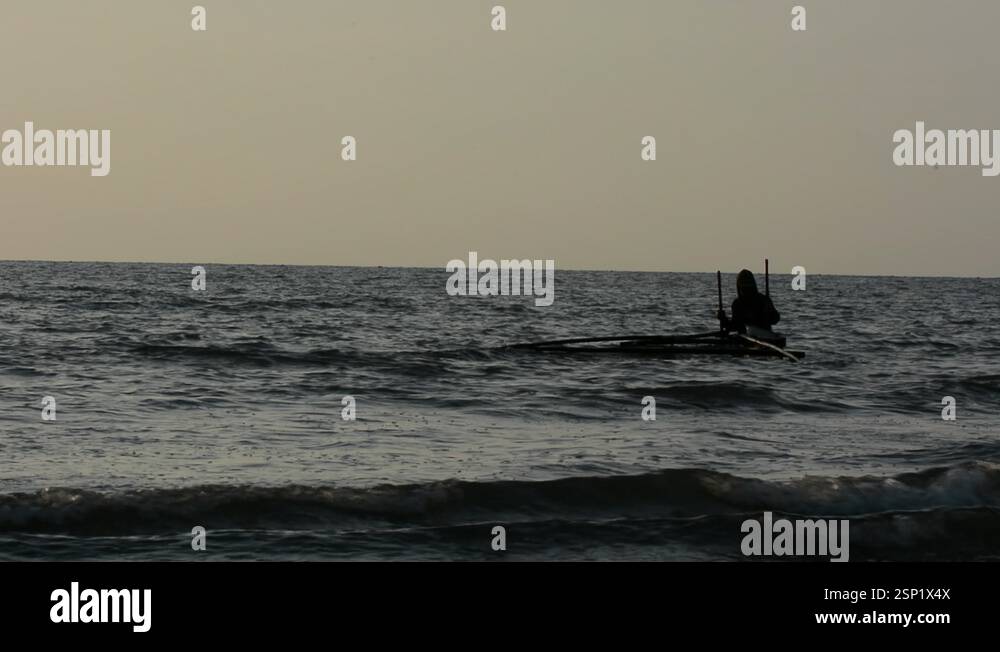 Man fishing for milkfish frie in shallow water in the Philippines Stock ...