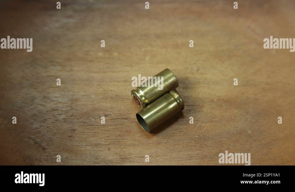 Two bullet casings falling and coming to rest center frame Stock Video ...