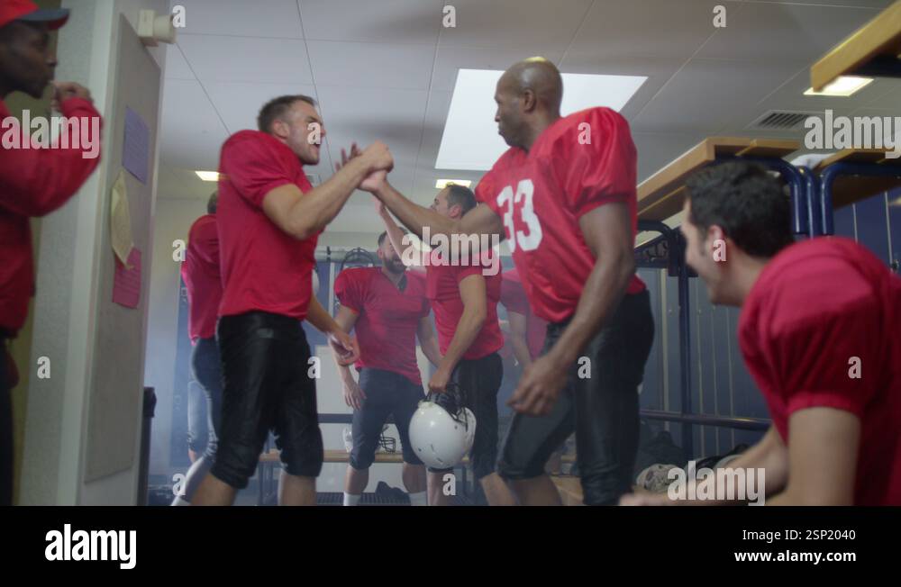4K Excited American footballers celebrate a victory by lifting coach in ...