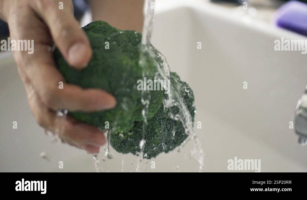 Man washing broccoli under tap water, slow motion shot at 480fps HD ...