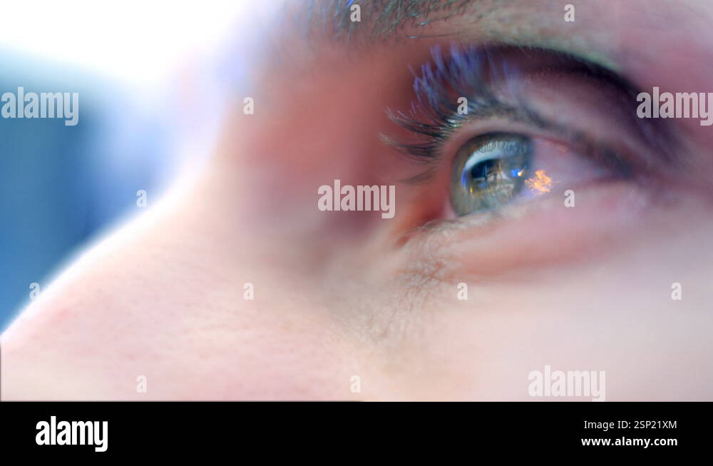 Reflection in the eye of the monitor screen when viewing video. Closeup ...