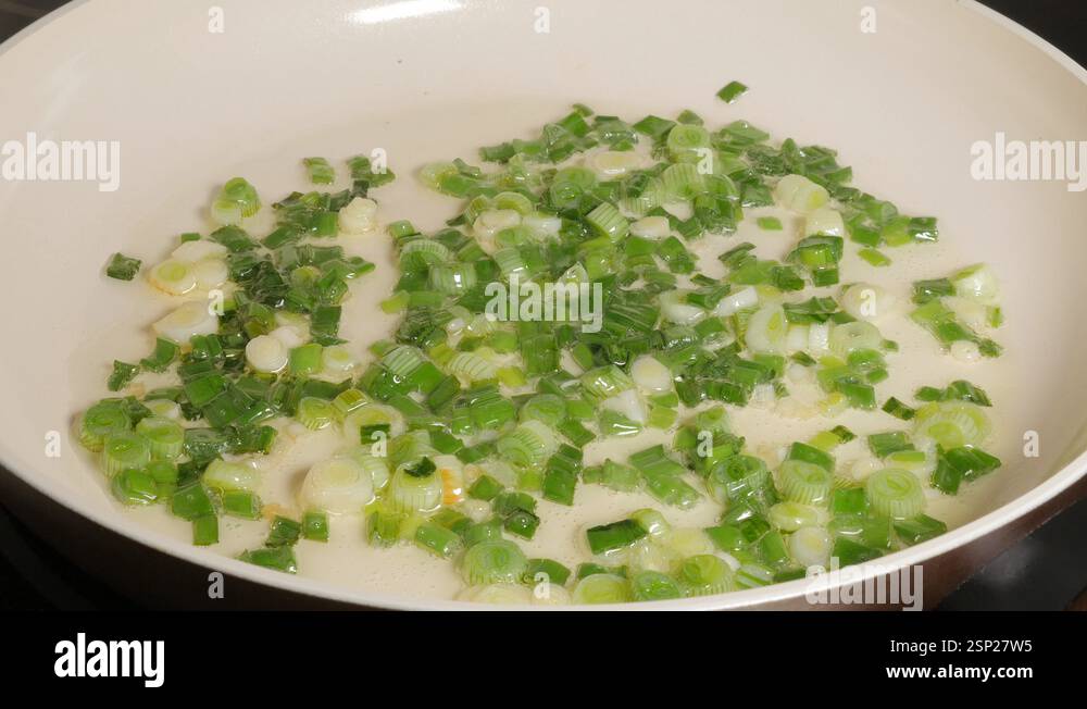Beaten eggs and green scallion onion in ceramic pan 4K 2160p UltraHD ...