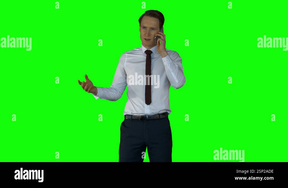 Irritated businessman having phone call on green screen Stock Video ...