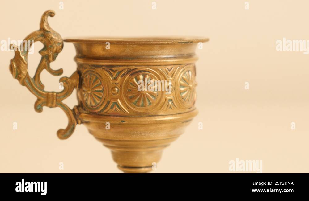 Holy grail made of brass on white reflective surface 4K 2160p UltraHD ...