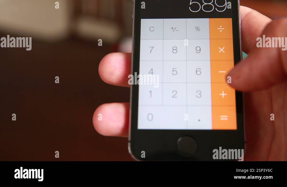 Man Is Making Arithmetic Operation With The Calculator Of The ...