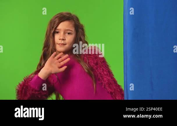 Children emotions concept. Little girl child peeks out and waves hand ...