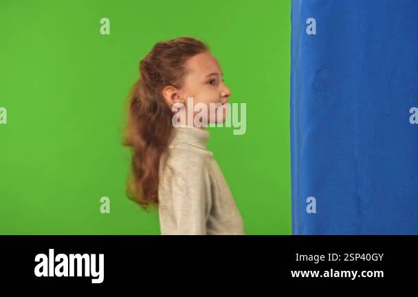 Children emotions concept. Girl child walking peeks out waves hand and ...