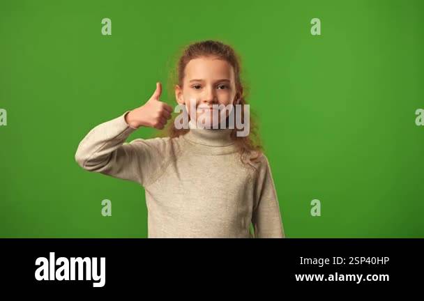 Children emotions concept. Little girl child looks at camera and shows ...