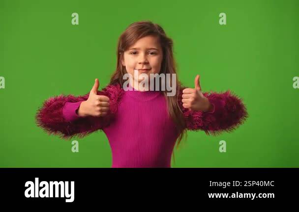 Children emotions concept. Smiling girl child looks at camera and shows ...