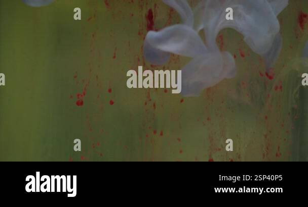 Falling color fluid. Ink water mix. Defocused red green blue shine ...