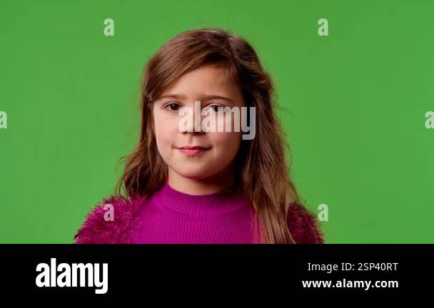 Children emotions concept. Smiling girl child looks at camera and shows ...