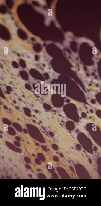 Vertical video. Fizzy fluid texture. Acid liquid. Defocused orange ...
