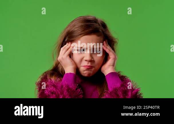 Children emotions concept. Little girl child has headache, holding face ...