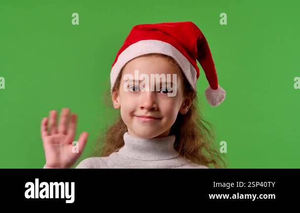 Children emotions concept. Smiling girl child in santa hat looks at ...