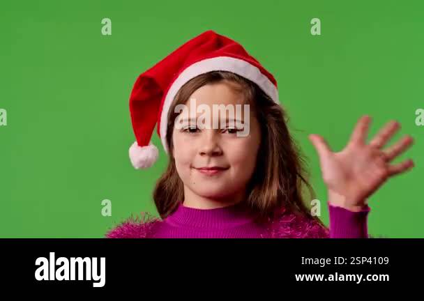 Children emotions concept. Smiling girl child in santa hat looks at ...