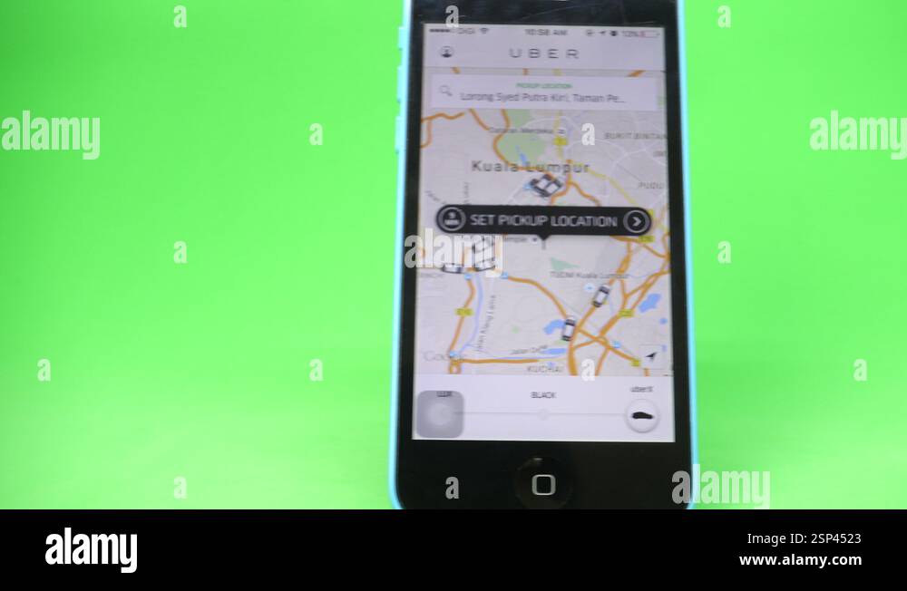 A smartphone with the Uber app showing the map of Kuala Lumpur Stock ...