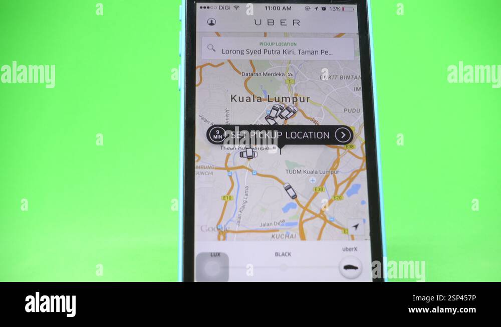 A smartphone with the Uber app showing the map of Kuala Lumpur Stock Video Footage - Alamy