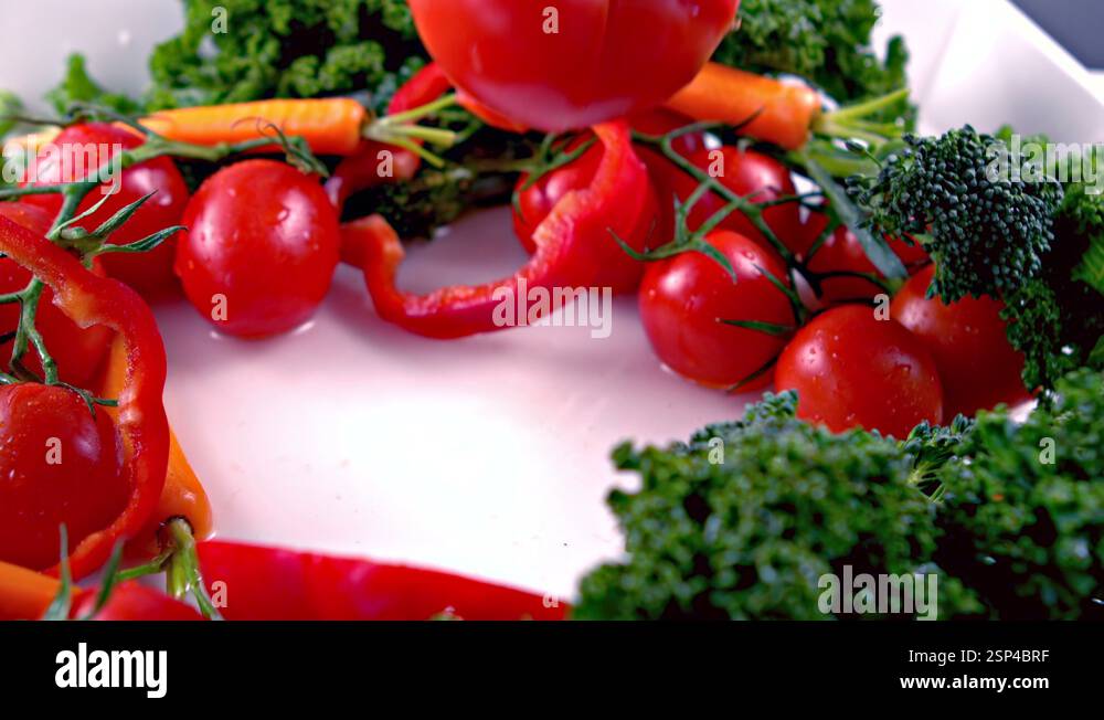 Cut tomato falling into water Stock Video Footage - Alamy