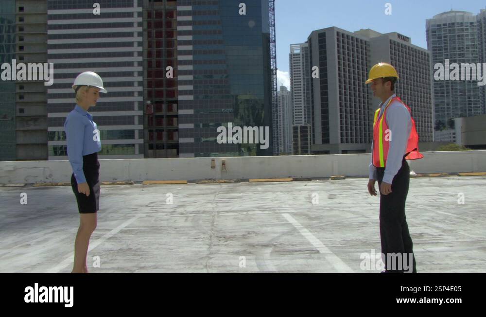 Male and female construction workers meet and shake hands Stock Video Footage - Alamy