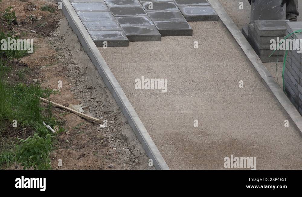 man hand put cement tiles to new footway, construction site. 4K Stock ...