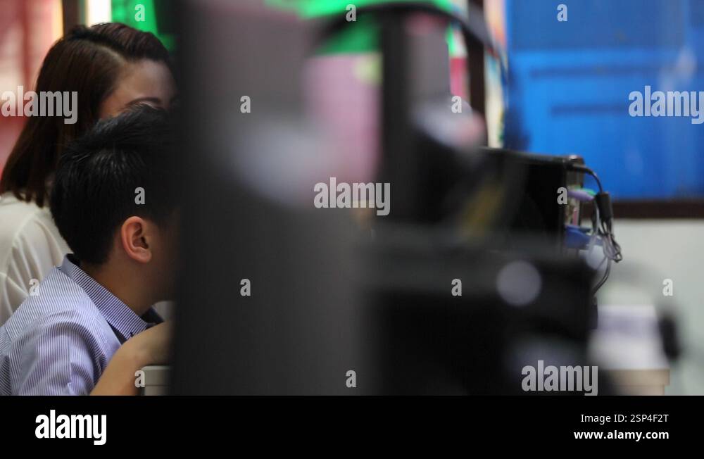 Asian sad child looking at the computer in library with their teacher ...