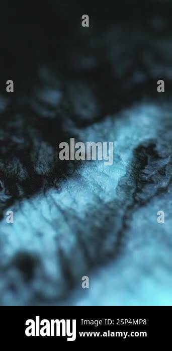 Vertical video. Shimmering motion. Sparkling emulsion flow. Cyan black texture blend liquid blue ...